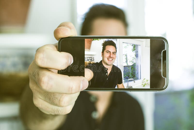 Guy Making a Selfi with a Cell Phone and Smiling at Home Stock Image ...