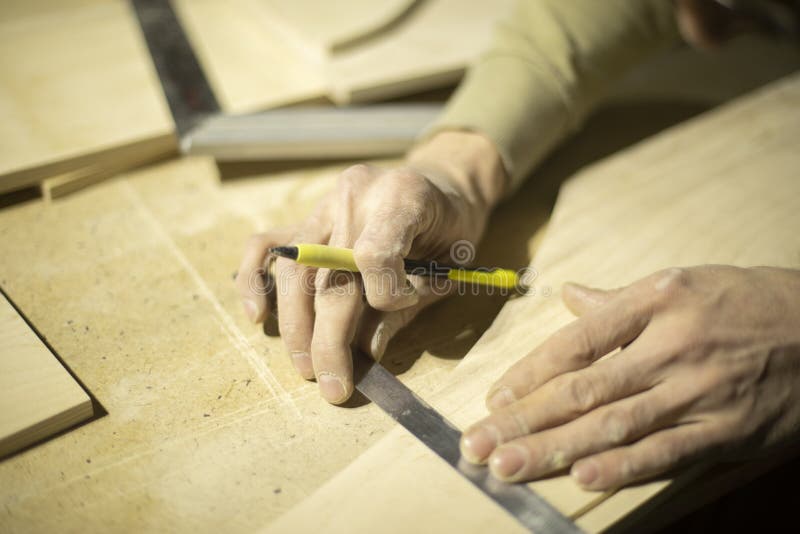 Guy Marks Board on Ruler. Marking with Pencil. Carpenter Measures ...