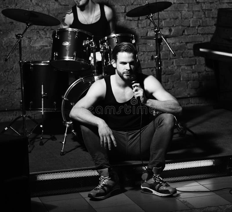 Guy with Microphone Sings in Studio or Bar. Stock Image - Image of drum ...
