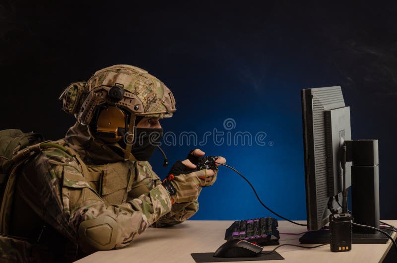 A Guy in a Military Uniform is Sitting Playing Computer Games on a ...