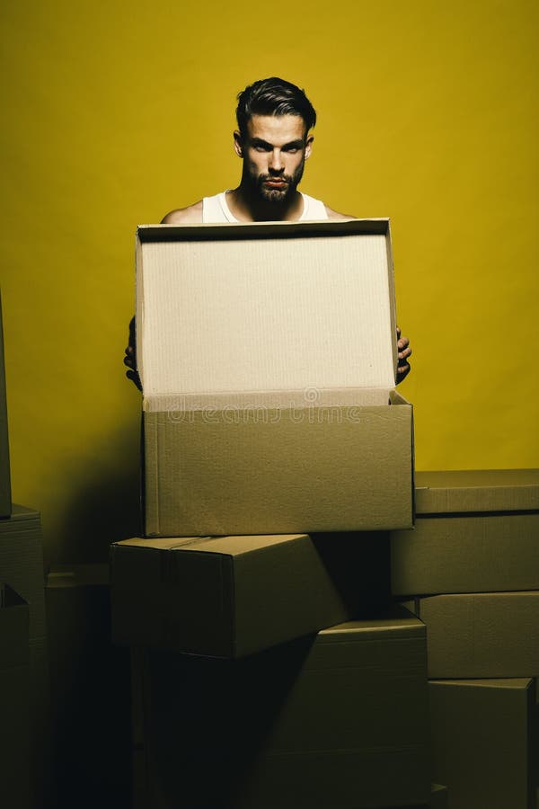 Guy with Muscular Torso Opens Box in Front. Stock Photo - Image of ...