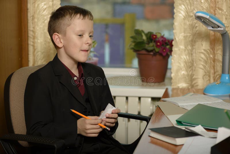 The Boy Works in His Office on a Personal Computer.he Writes a L Stock ...