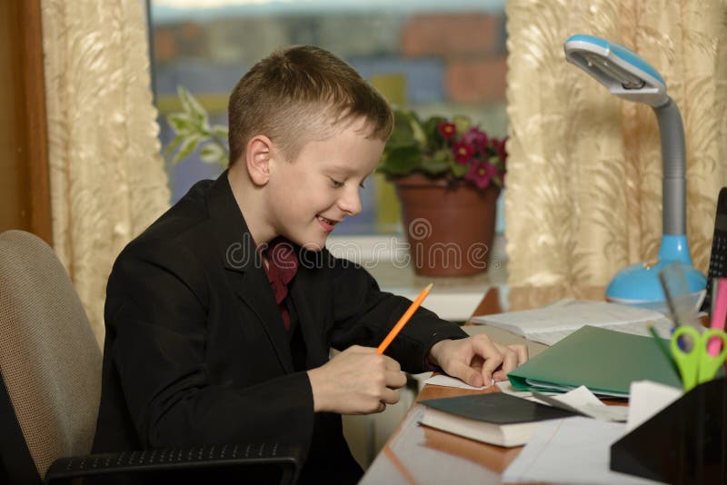 The Boy Works in His Office on a Personal Computer.he Writes a L Stock ...