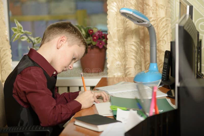 The Boy Works in His Office on a Personal Computer.he Writes Wit Stock ...