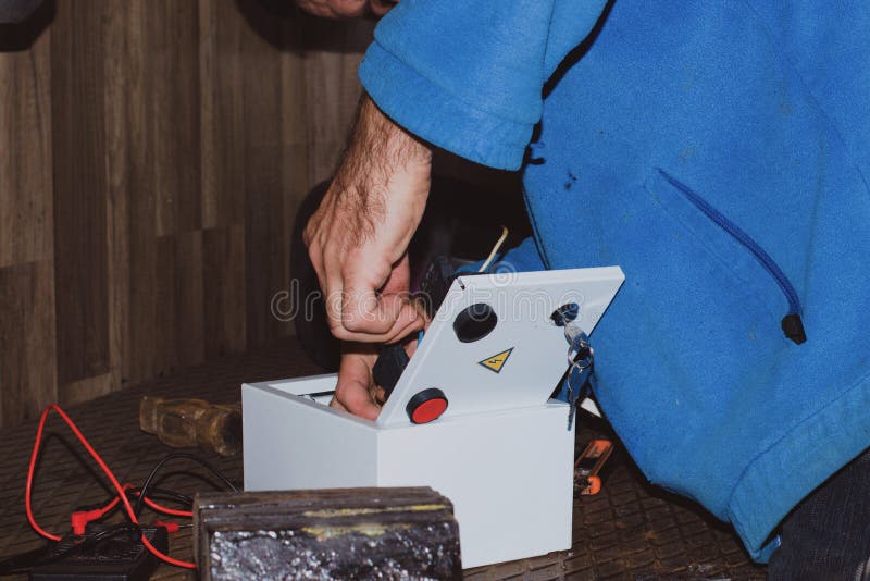The Guy Performs the Installation of an Electrical Panel. Stock Photo ...
