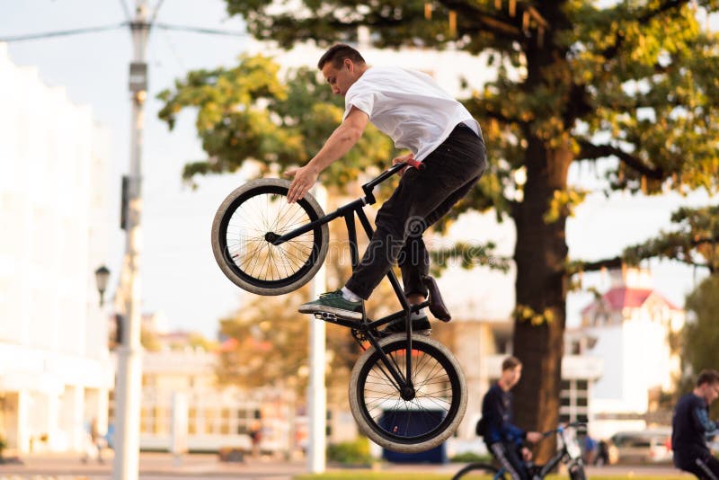 The Guy Performs a Stunt on BMX, Jumping High Up, and Touches the Front ...