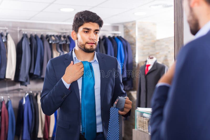 Guy is Picking Up Tie for Jacket in Front of the Mirror Stock Image ...