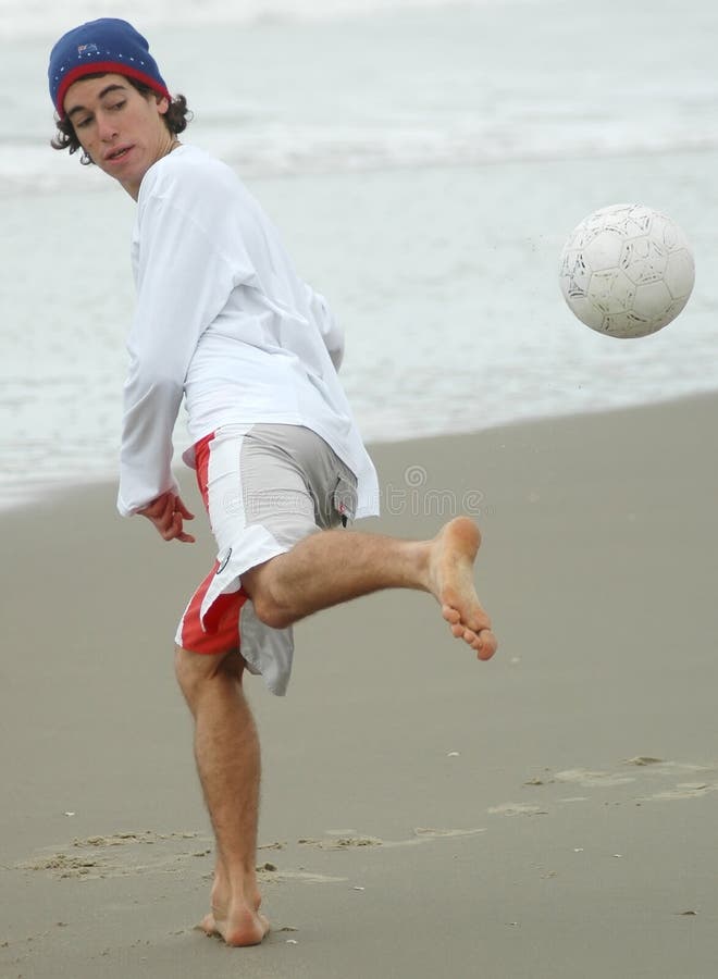Guy playing beach soccer stock image. Image of balance - 919759