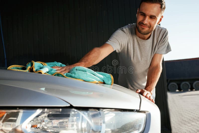 Guy is Polishing the Surface of Automobile by Using Cloth. Man is with ...