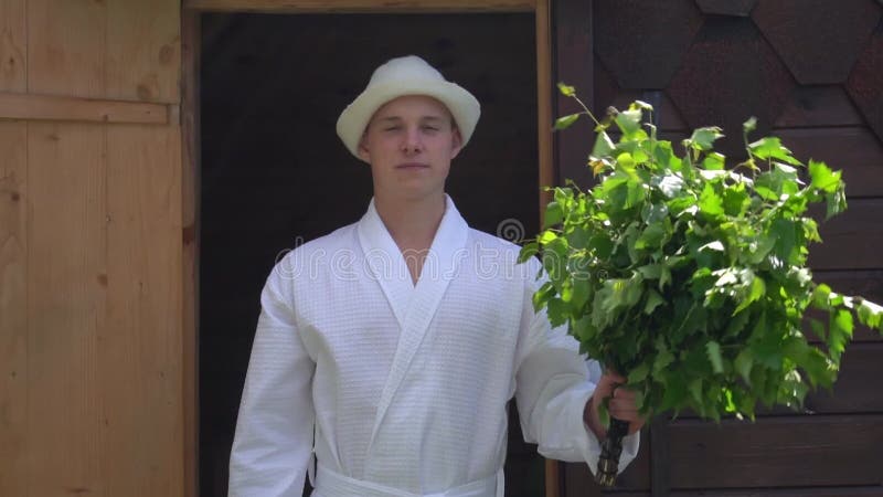 Guy is Preparing for Bath Procedures, Made a Birch Broom and Poses on ...