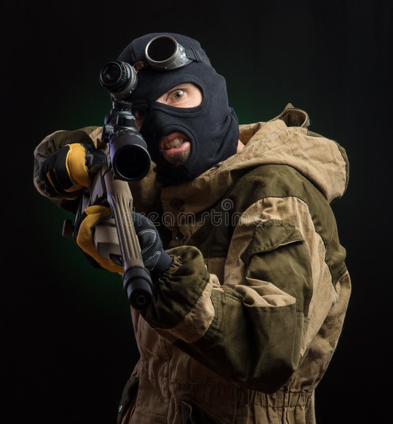 The Guy in Protective Clothing and a Black Mask with a Sniper Rifle ...