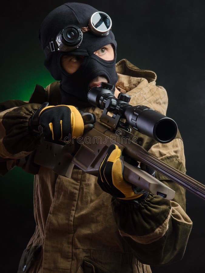 The Guy in Protective Clothing and a Black Mask with a Sniper Rifle ...