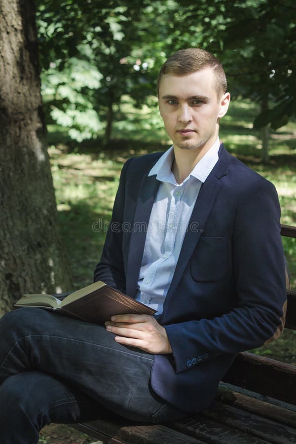 The guy is reading a boo stock image. Image of beautiful - 188532799