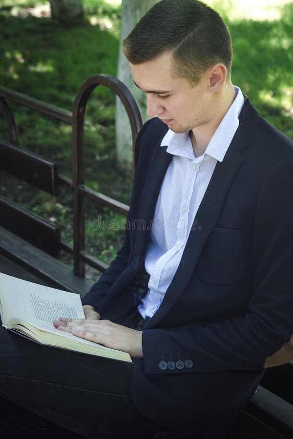 The guy is reading a book. stock image. Image of reading - 188532805