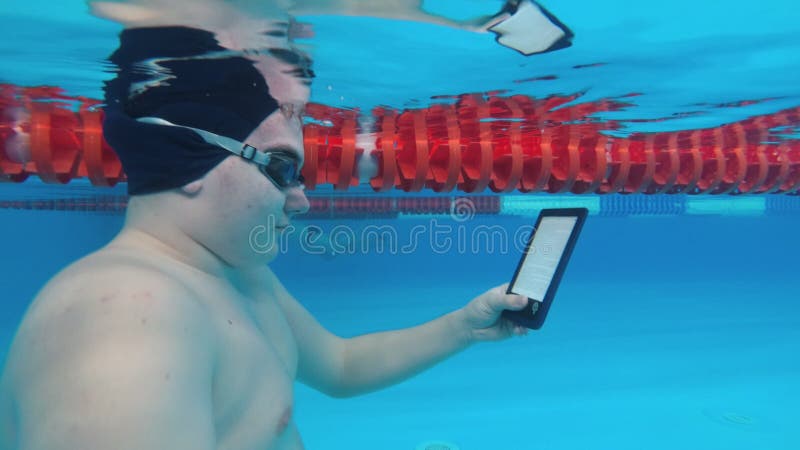The Guy is Reading an Electronic Book Underwater. Stock Photo - Image ...