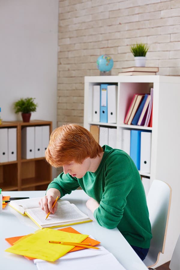 Guy reading encyclopaedia stock photo. Image of book - 55224258