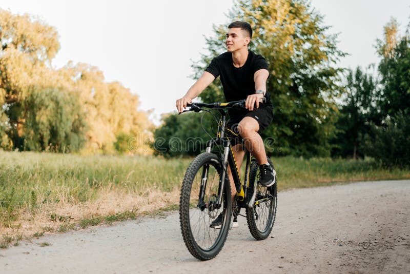A Man Rides a Bicycle Along a Path in the Park Stock Image - Image of ...