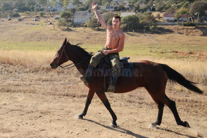 The guy is riding a horse3 stock photo. Image of jumps - 89428314