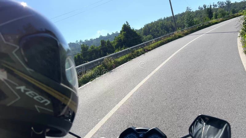 The Guy is Riding a Motorcycle, the Helmet is Visible on the Left Side ...