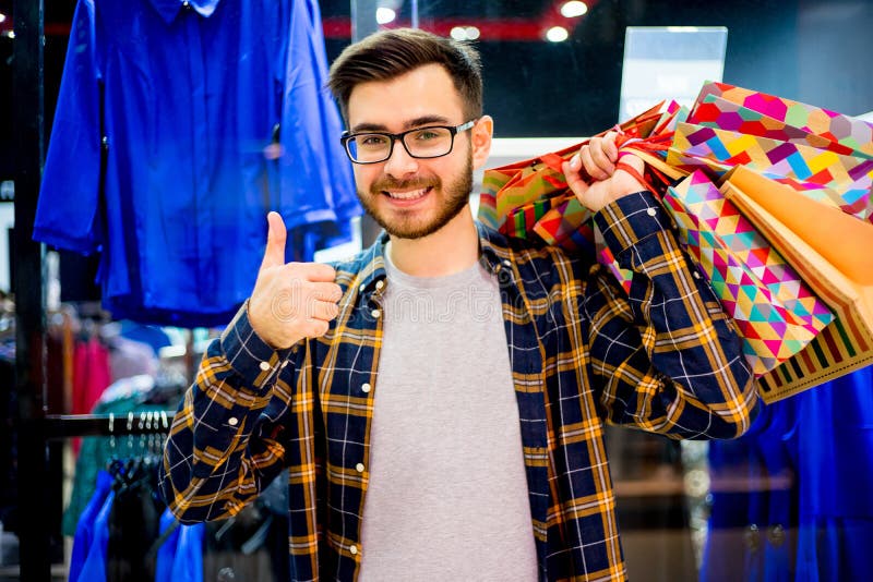 Guy shopping in a mall stock image. Image of looking - 94454445