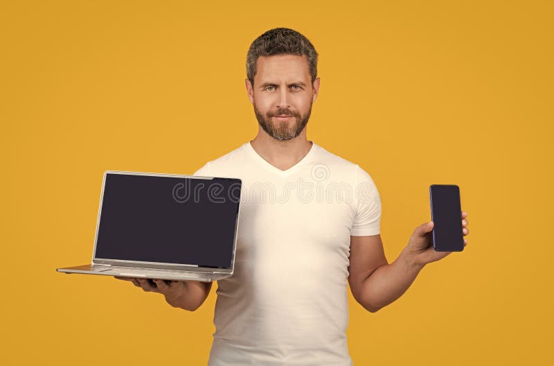 Guy Showing Smartphone and Laptop Screen in Studio. Guy Showing Screen ...