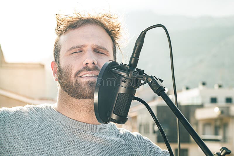 Guy singing on a rooftop stock photo. Image of music - 115366564
