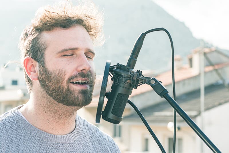 Guy singing on a rooftop stock photo. Image of casual - 115366598