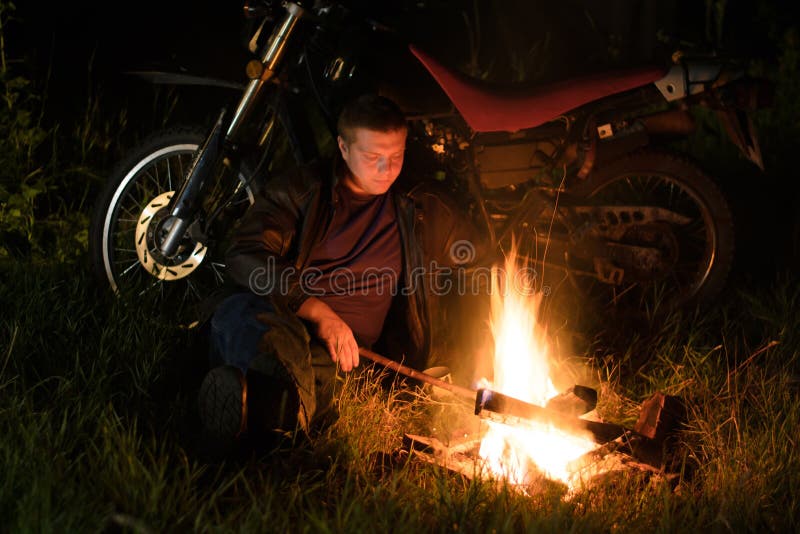 The Guy Sits by the Fire and Motorcycle at Night Stock Image - Image of ...