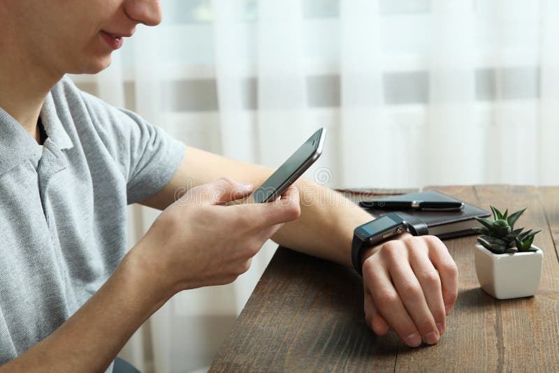 The Guy with a Smart Clock and a Smartphone. Stock Image - Image of ...