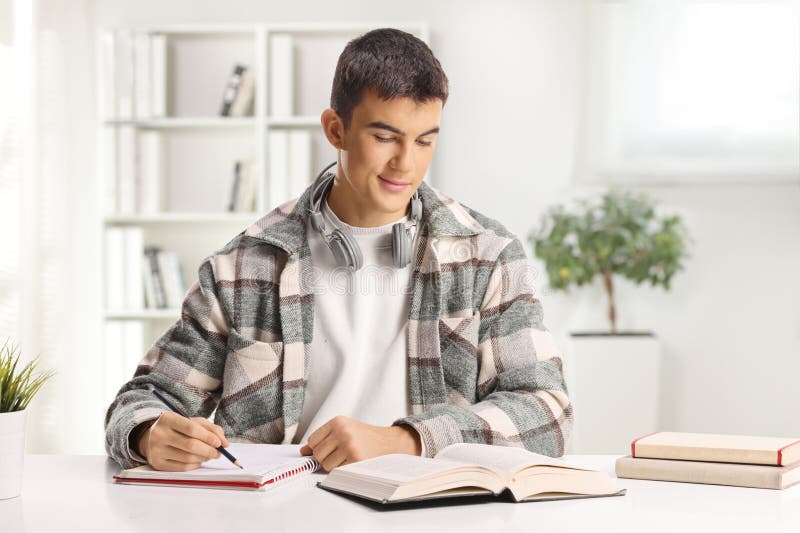 Guy Sitting at a Desk and Writing in a Notebook Stock Photo - Image of ...