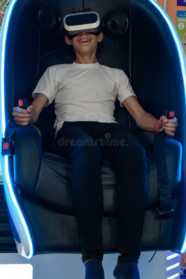 A Guy is Sitting on a Ride with Vr Glasses, Stock Photo - Image of room ...