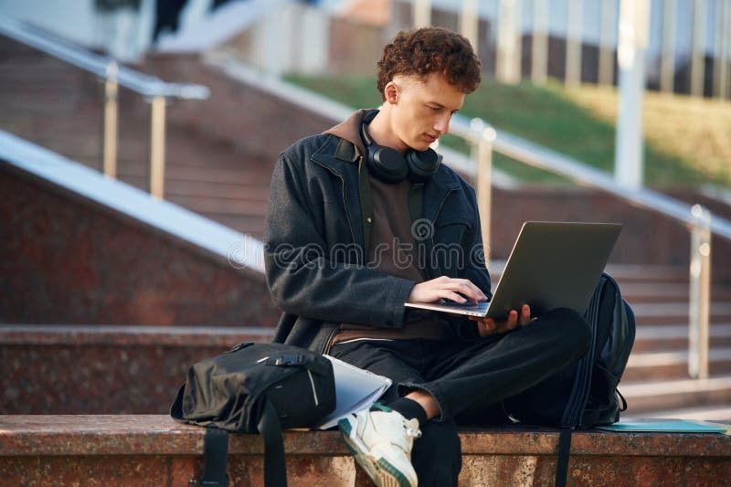 Guy is Sitting and Using Laptop. Young Student is Outside the ...