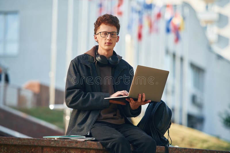 Guy is Sitting and Using Laptop. Young Student is Outside the ...