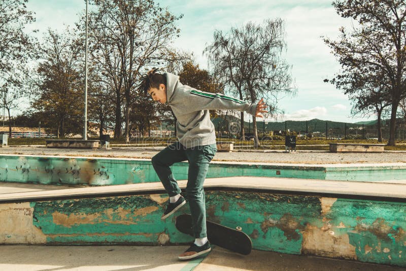 Guy Practicing Skateboarding and Doing Tricks in a Skatepark Stock ...