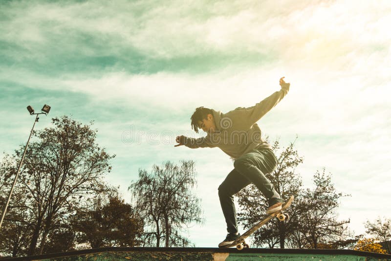 Guy Practicing Skateboarding and Doing Tricks in a Skatepark Stock ...