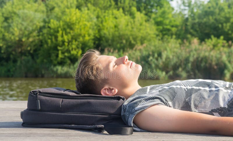 Guy sleeping on a backpack stock photo. Image of peaceful - 199191814