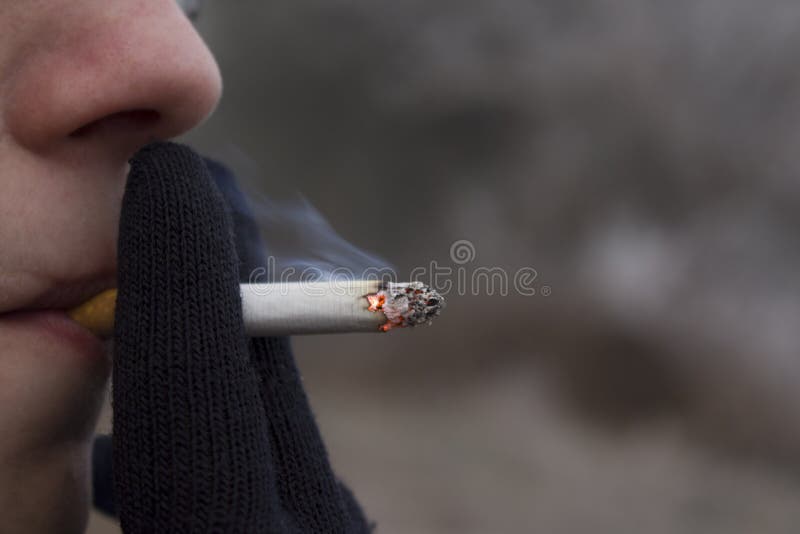 Guy smoking cigarette stock photo. Image of gloves, fire - 83434968