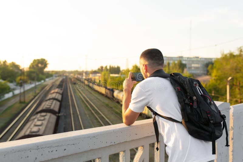The Guy Standing on the Bridge Photographs the Railway Tracks at Sunset ...