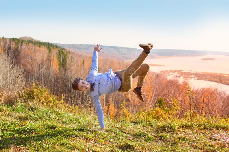 Guy standing on one hand stock image. Image of pants - 60926783