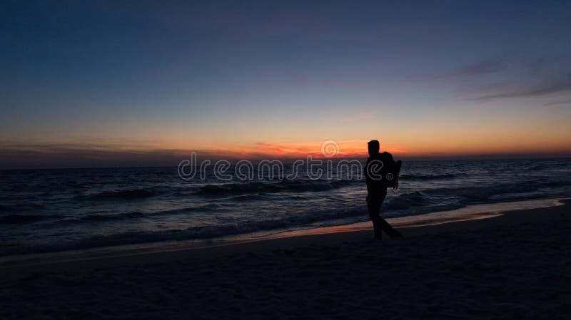 Guy Stands in Front of Dramatic Sunset Over the Ocean Stock Image ...