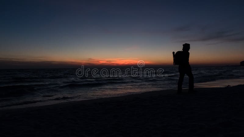 Guy Stands in Front of Dramatic Sunset Over the Ocean Stock Image ...