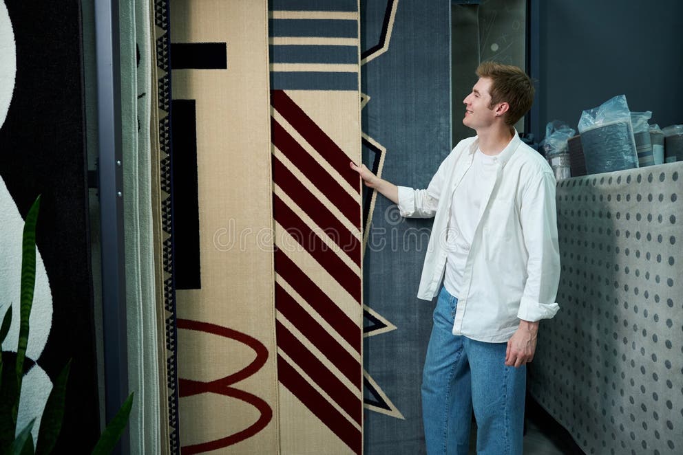 Guy Stands at a Rack with Carpet Samples Stock Image - Image of ...