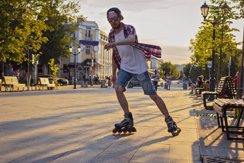 A Guy on the Street is Roller Skating at Sunset 2 Stock Photo - Image ...