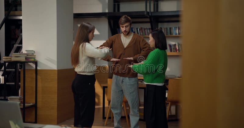 A Guy Student with His Female Colleagues Perform Breathing Techniques ...