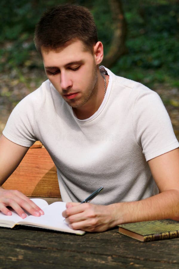 Guy and Student Takes Notes in Notebook, Learning and Writes Thoughts ...