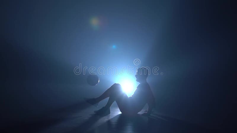 Guy Stuffing Ball, Making Tricks Sitting on Floor. Slow Motion Stock ...