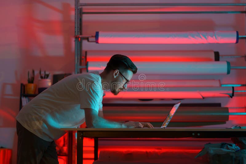 Guy Stylist or Fashion Designer Work on Laptop in Studio. Tailor Use ...