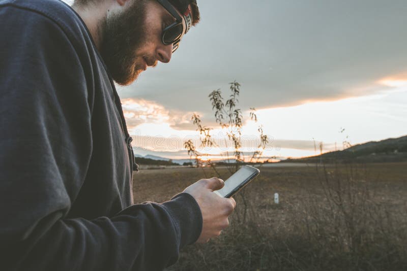 Guy with Sunglasses and Cap Looking at the Mobile Phone.People Watching ...