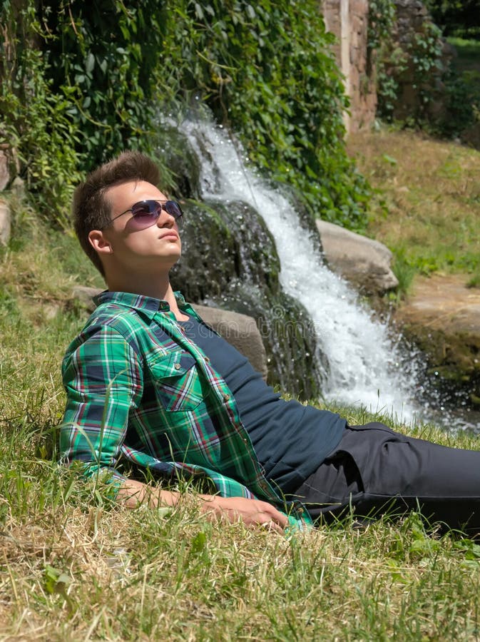 Guy in Sunglasses Relaxing in Nature Near the Waterfall Stock Photo ...