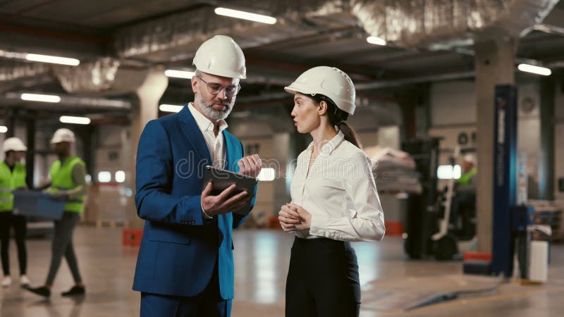Supervisor Talking with Manager Using Tablet at Warehouse. Inside Stock ...